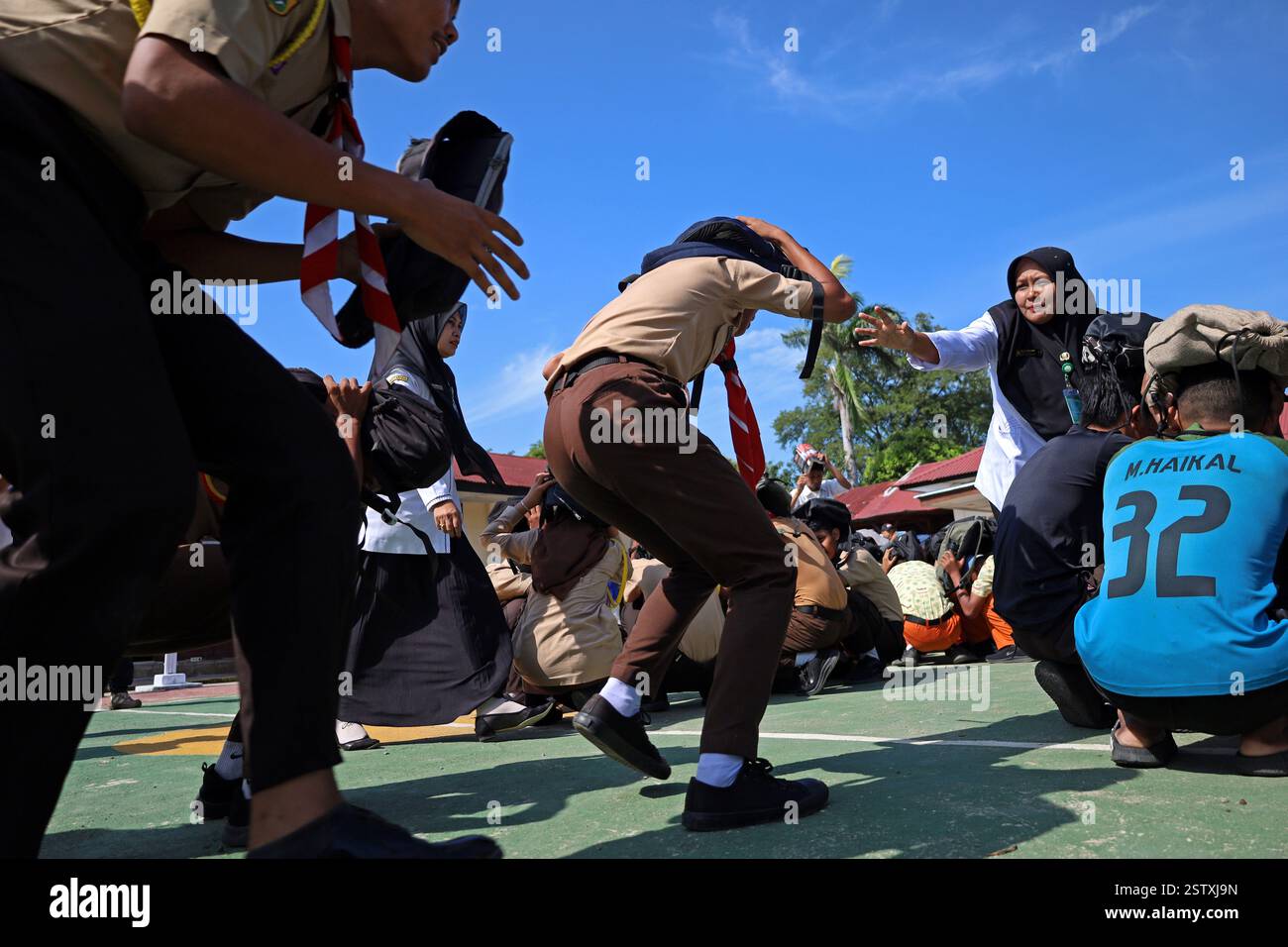 February 20, 2025, Banda Aceh, Aceh, Indonesia: Students run with bags ...