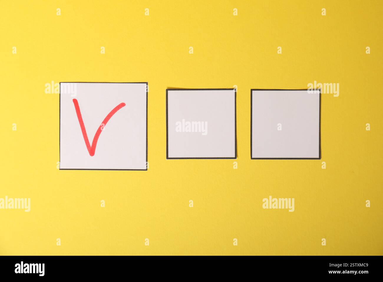 One checkbox with tick mark among others on yellow background, flat lay ...