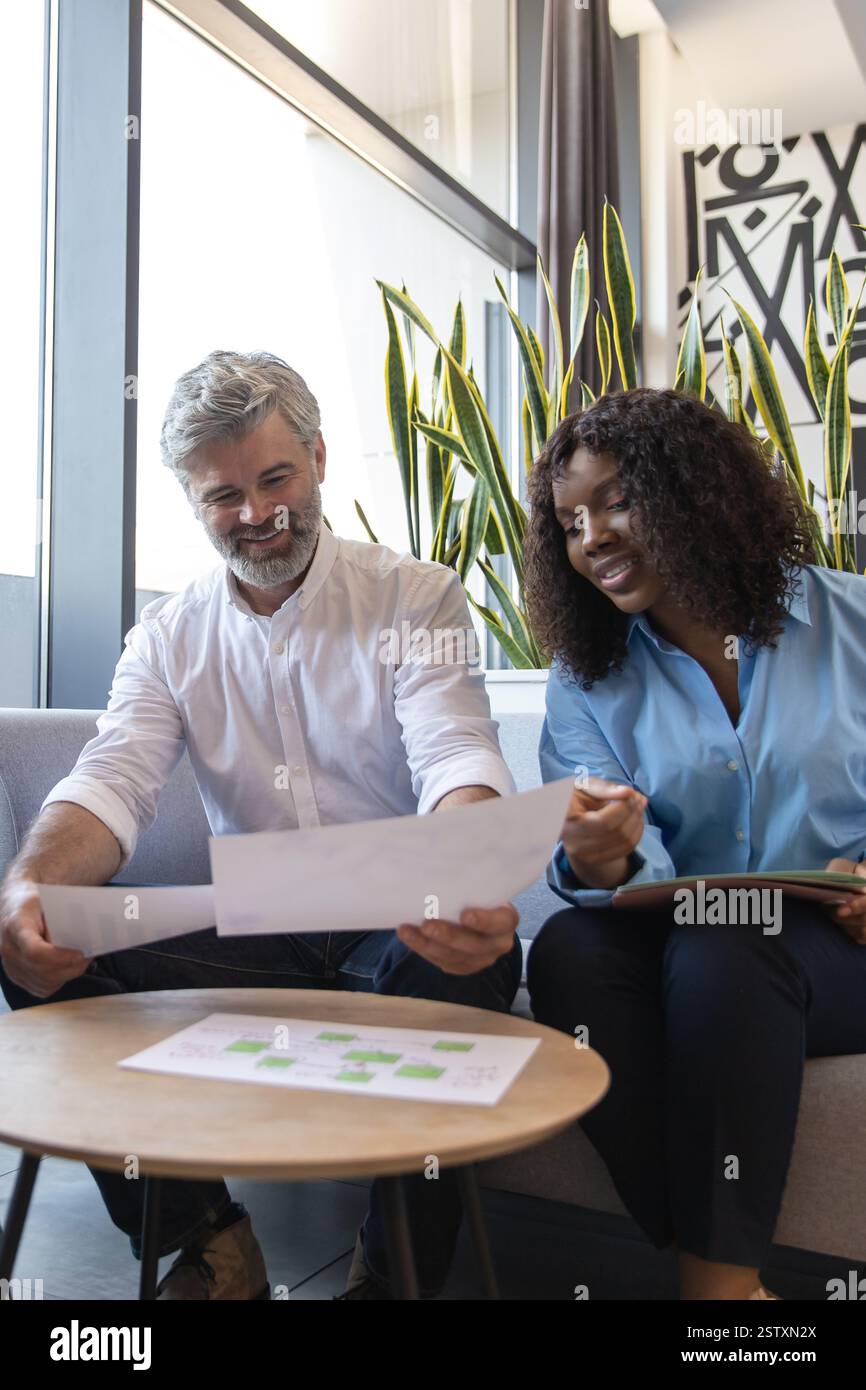 Businessman and businesswoman engaging in corporate discussion ...