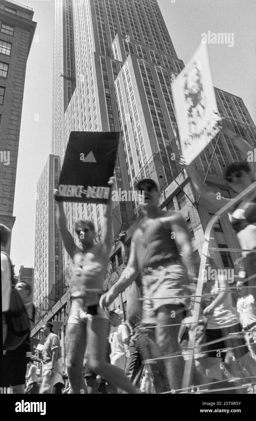 marchers with raised placard: Silence equals death during NYC Pride ...