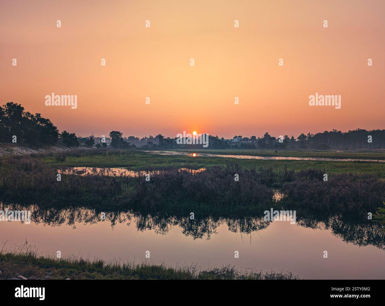 Majestic sunrise over Asan Barrage, Dehradun, with orange sky and vast ...