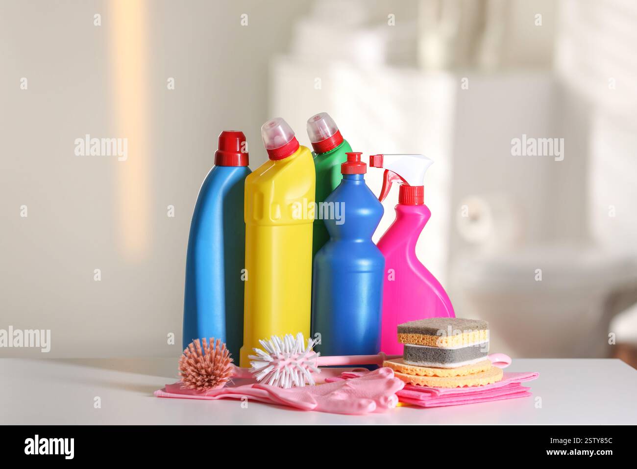 Different detergents and cleaning supplies on table in bathroom Stock ...