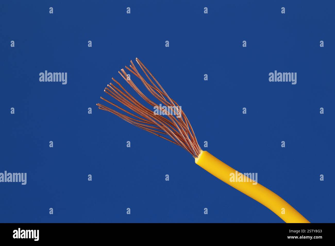Yellow stripped electrical wire on blue background, closeup Stock Photo ...