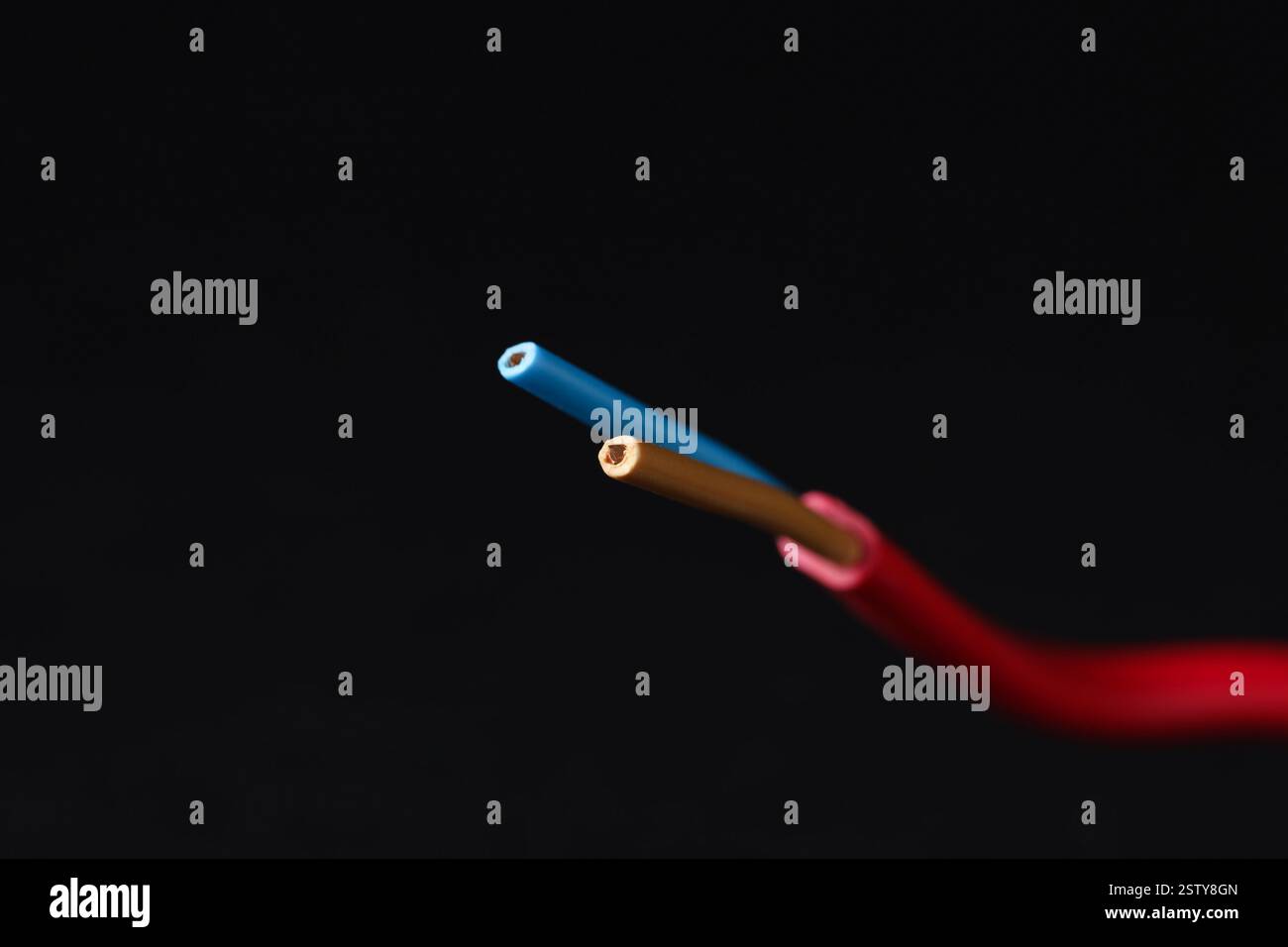 Red stripped electrical wire on black background, closeup Stock Photo ...