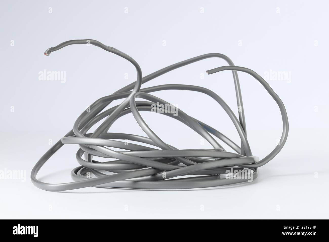 Insulated grey electrical wire isolated on white Stock Photo - Alamy