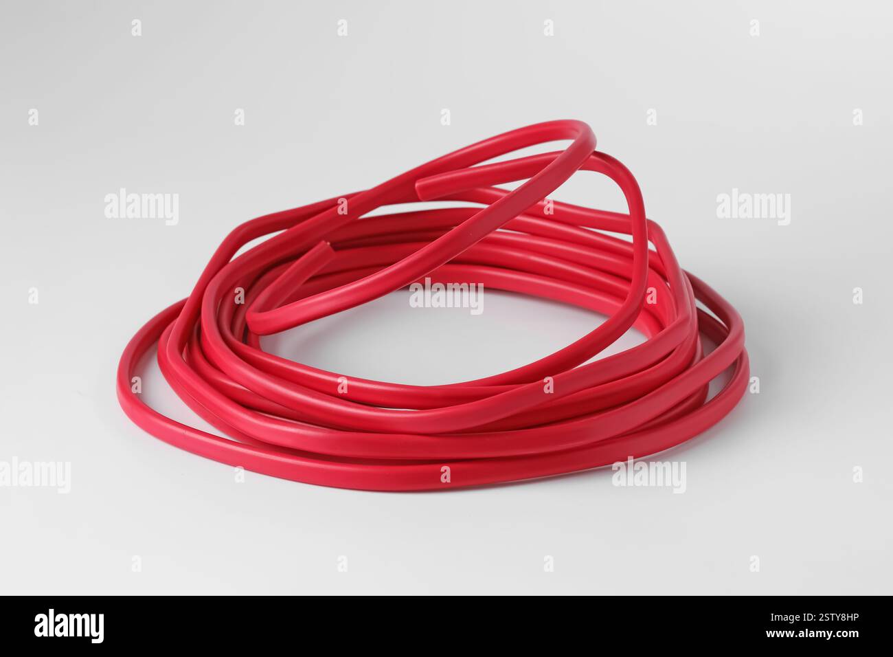 Insulated red electrical wire isolated on white Stock Photo - Alamy