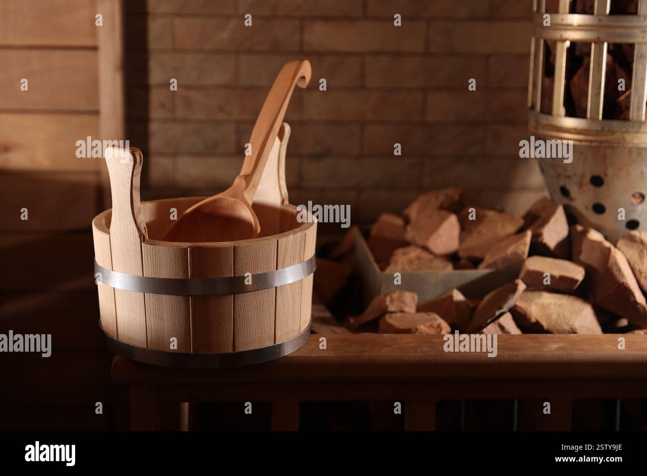 Bucket, ladle and stove with hot rocks in sauna Stock Photo - Alamy