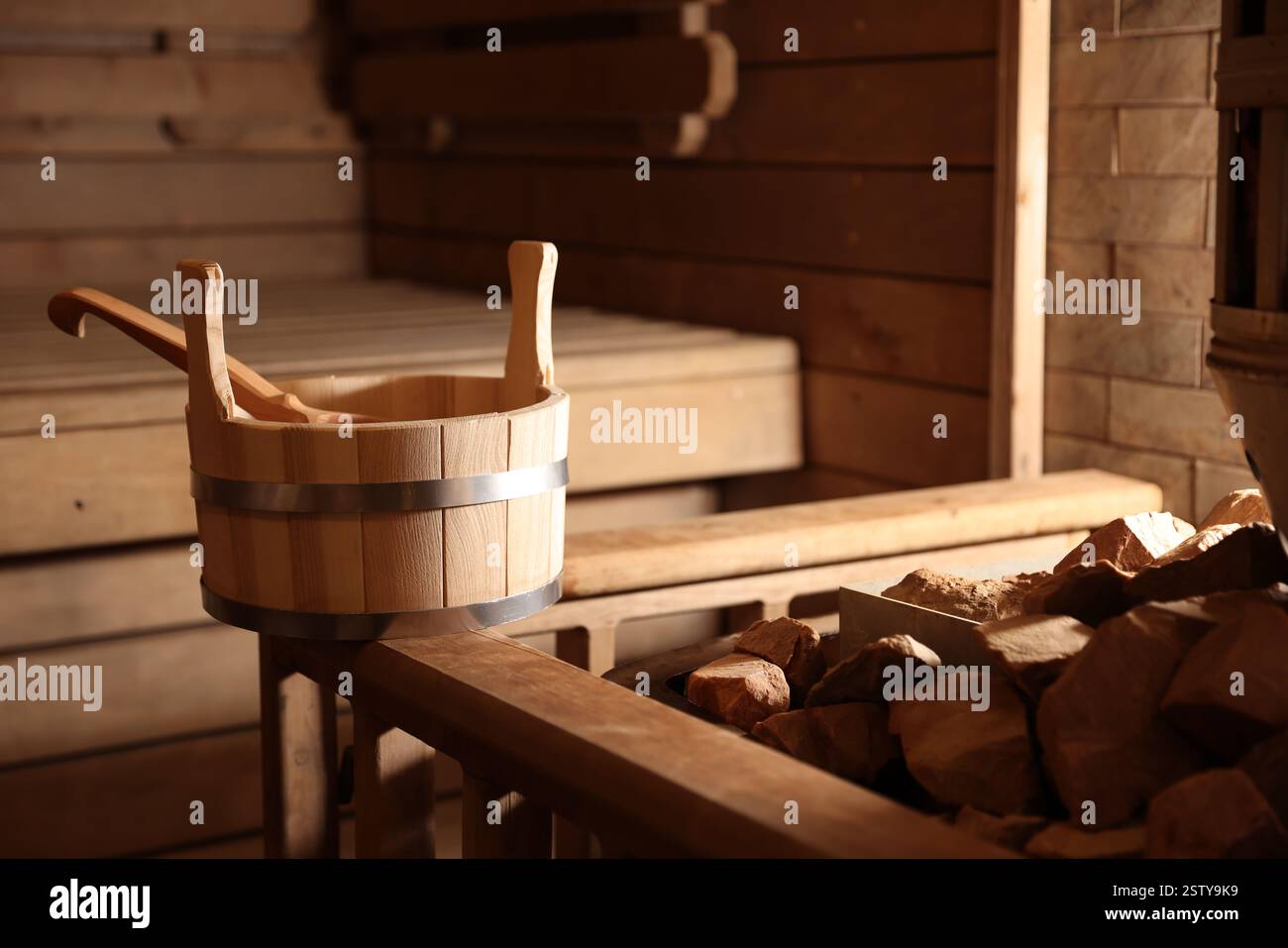 Bucket, ladle and hot rocks in sauna Stock Photo - Alamy