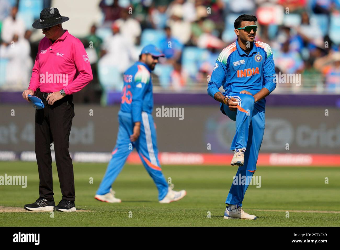 India's Axar Patel, right, rubs to shine the ball during the ICC ...