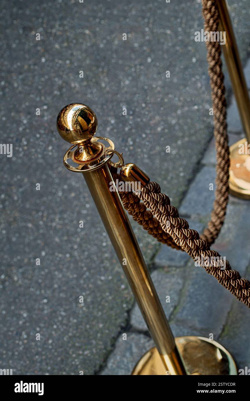Brass queue cord in a street Stock Photo - Alamy