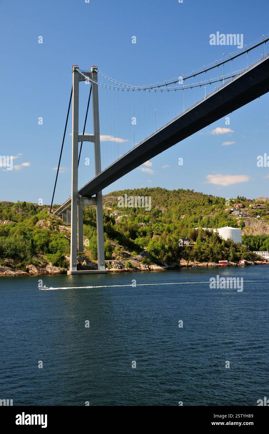 Sailing under Askoy Bridge, a road suspension bridge at Bergen in ...