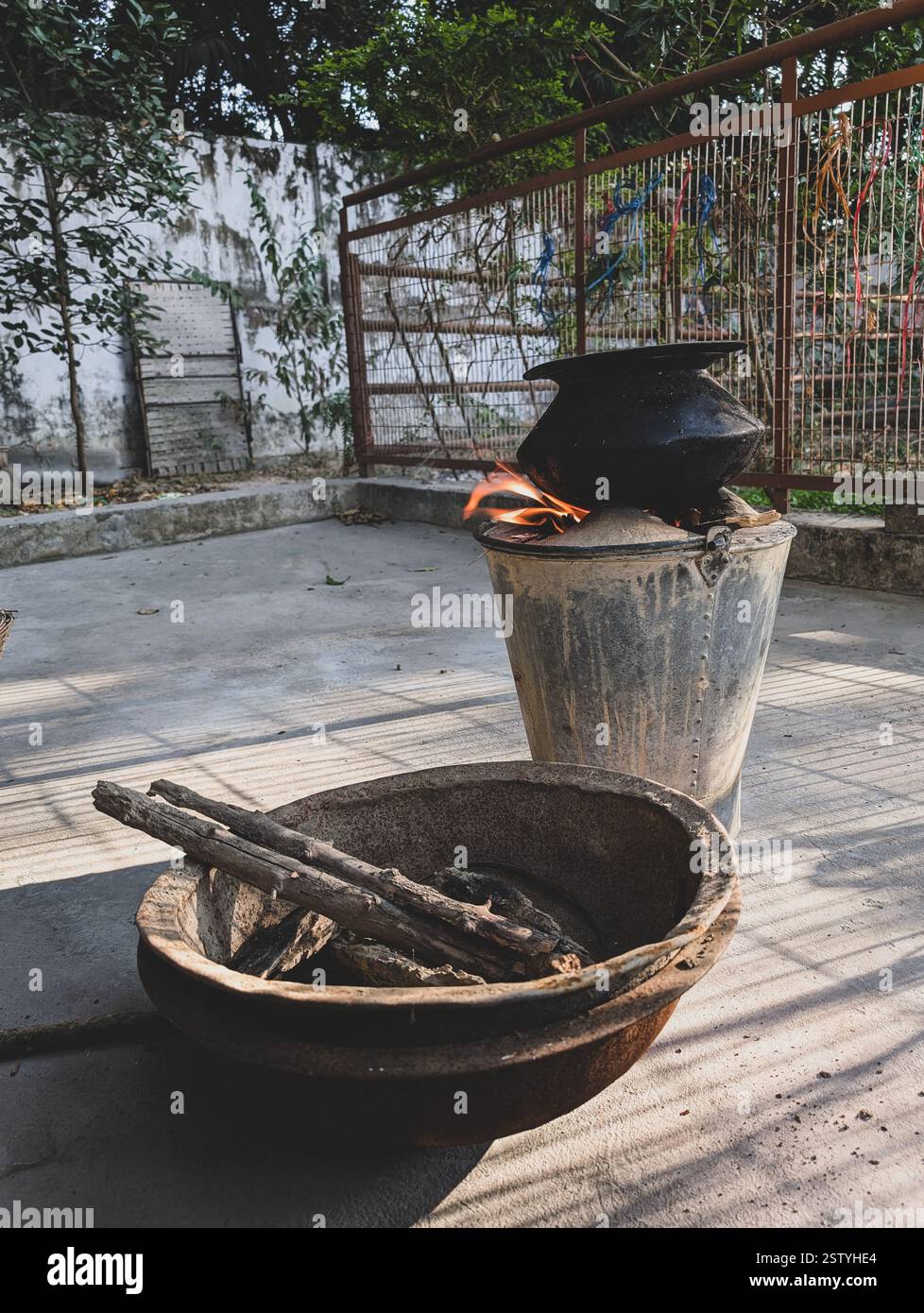 A traditional cooking scene with a backyard mud stove, angeethi ...