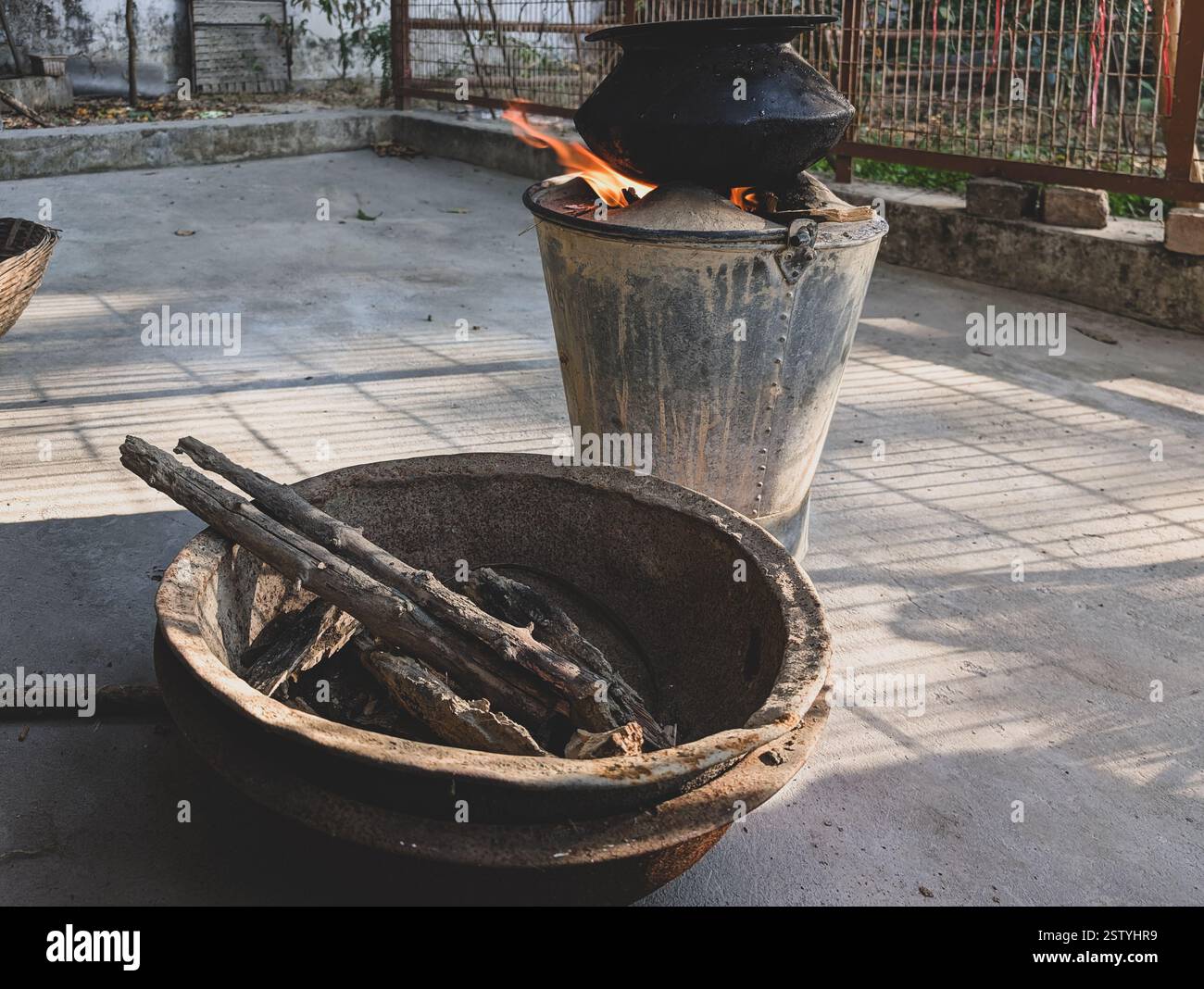 A traditional cooking scene with a backyard mud stove, angeethi ...