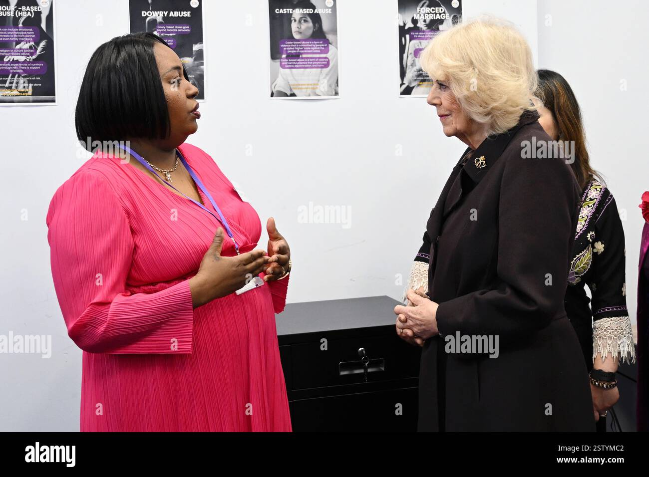 Queen Camilla (right) meets staff during a visit to the Asian Women's ...