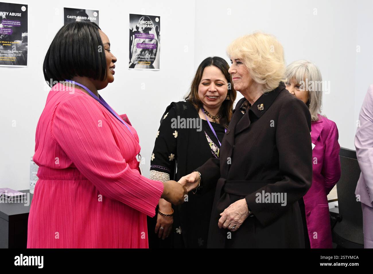 Queen Camilla meets staff during a visit to the Asian Women's Resource ...