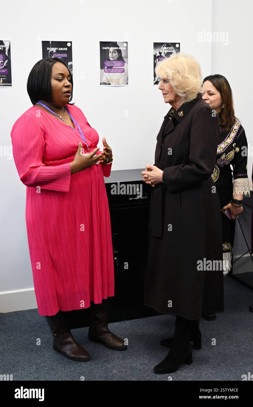 Queen Camilla (right) meets staff during a visit to the Asian Women's ...