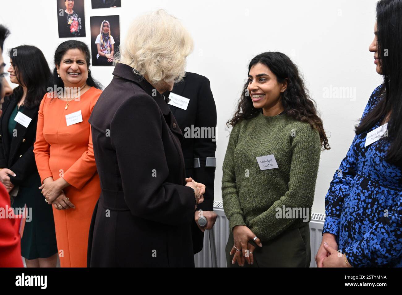 Queen Camilla (centre) meets trustee Kashi Syal during a visit to the ...
