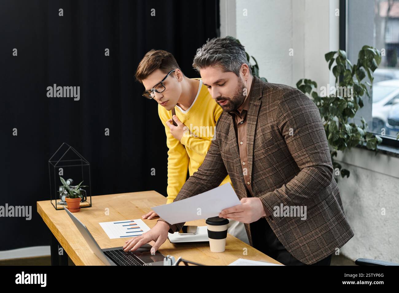 Two new employees engage in a collaborative onboarding session at a ...