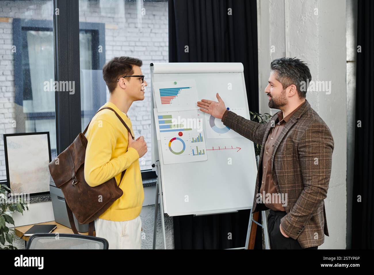 A new employee listens attentively during an onboarding session while ...