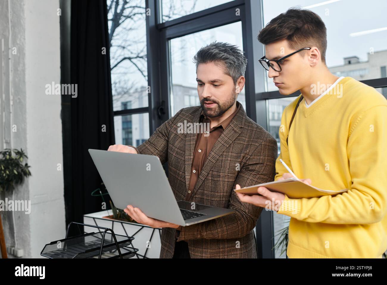 A new employee is receiving guidance from a mentor while starting their ...