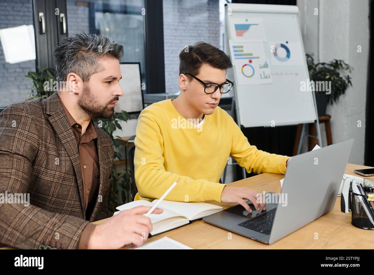 Two colleagues work together on the first day of a new job in a ...