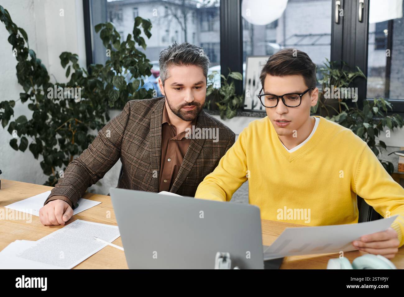 Exchanging documents colleagues office desk hi-res stock photography ...