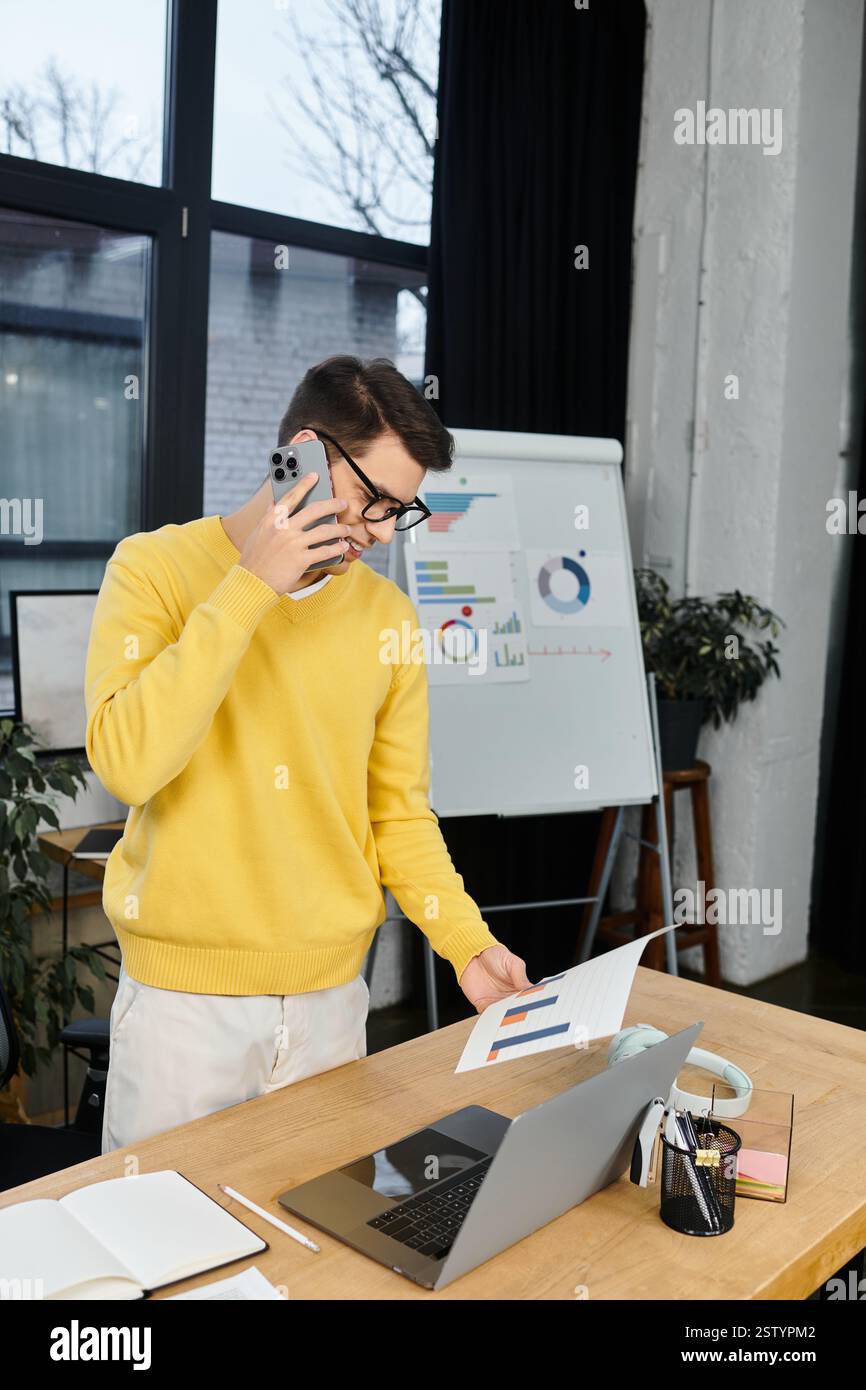 New employee connects with colleagues over the phone while reviewing ...