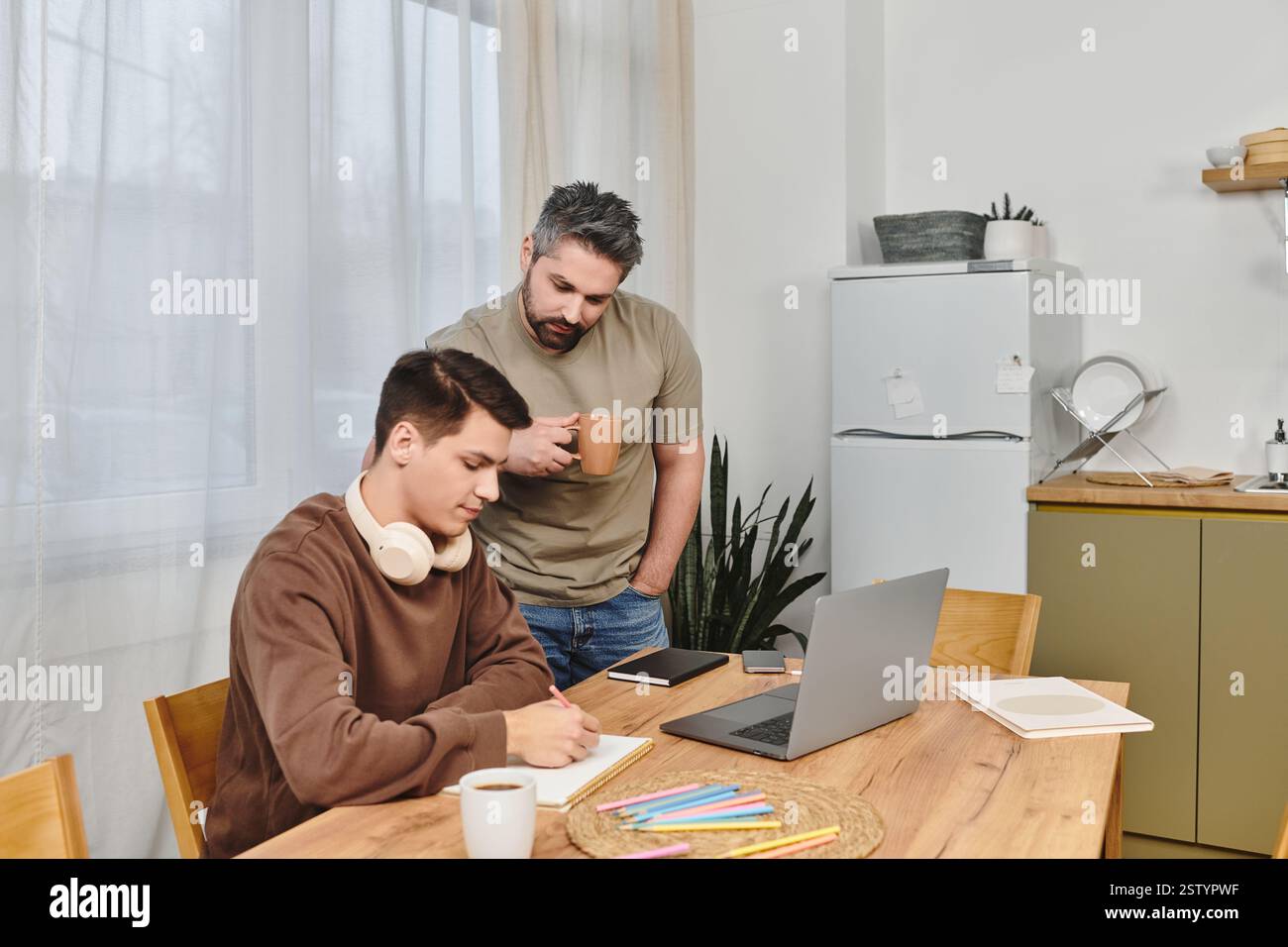 A young man writes creatively at home with support and encouragement ...