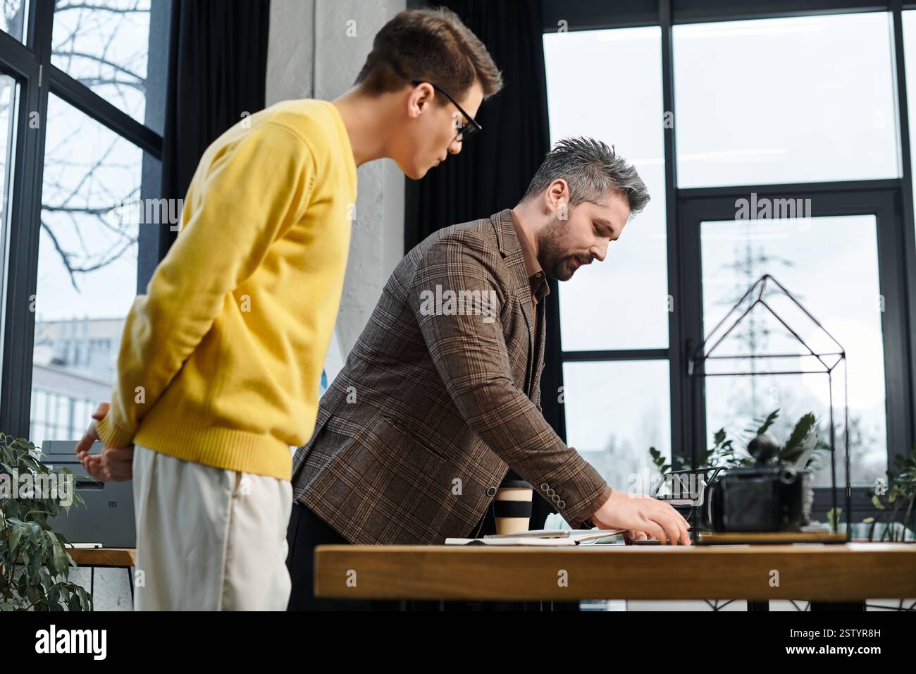 Two colleagues engage in onboarding activities as a new employee begins ...