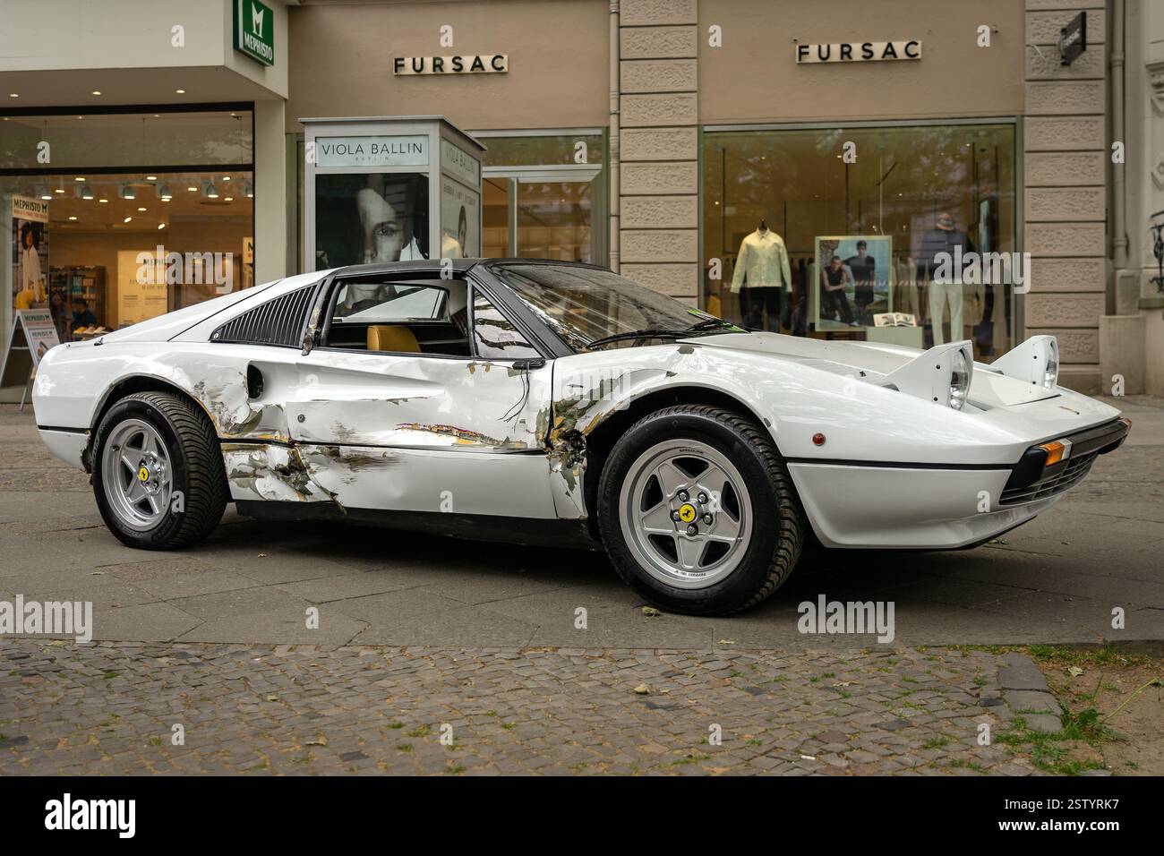 The sports car Ferrari 308 GTS with a broken body after a car accident ...