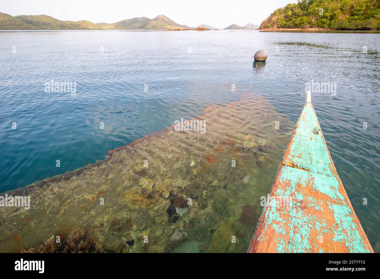 Bow of a banca floating above a sunken World War II shipwreck off ...