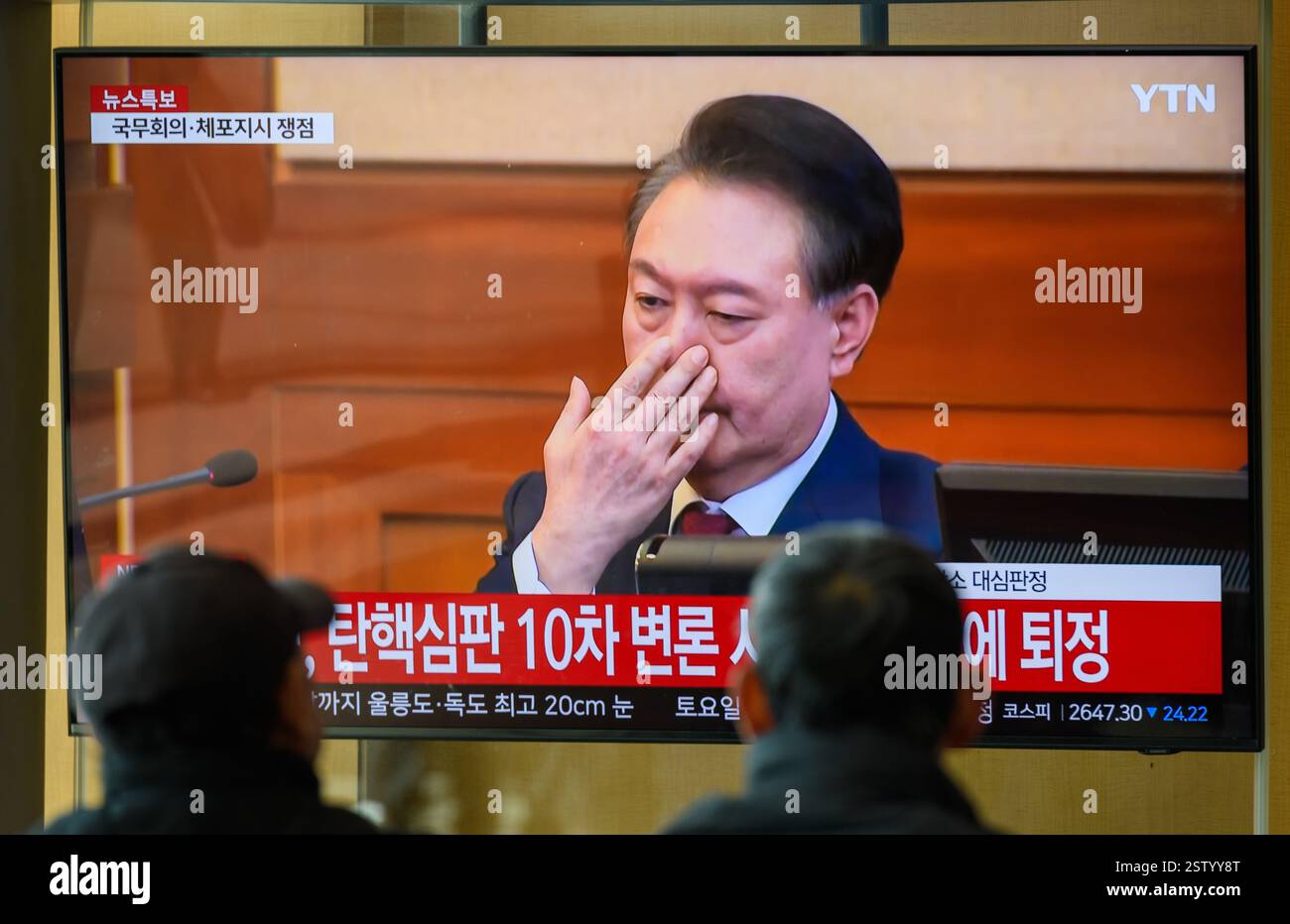 A 24-hour YTN TV broadcast at Seoul Railway Station shows a news broadcast with impeached South ...
