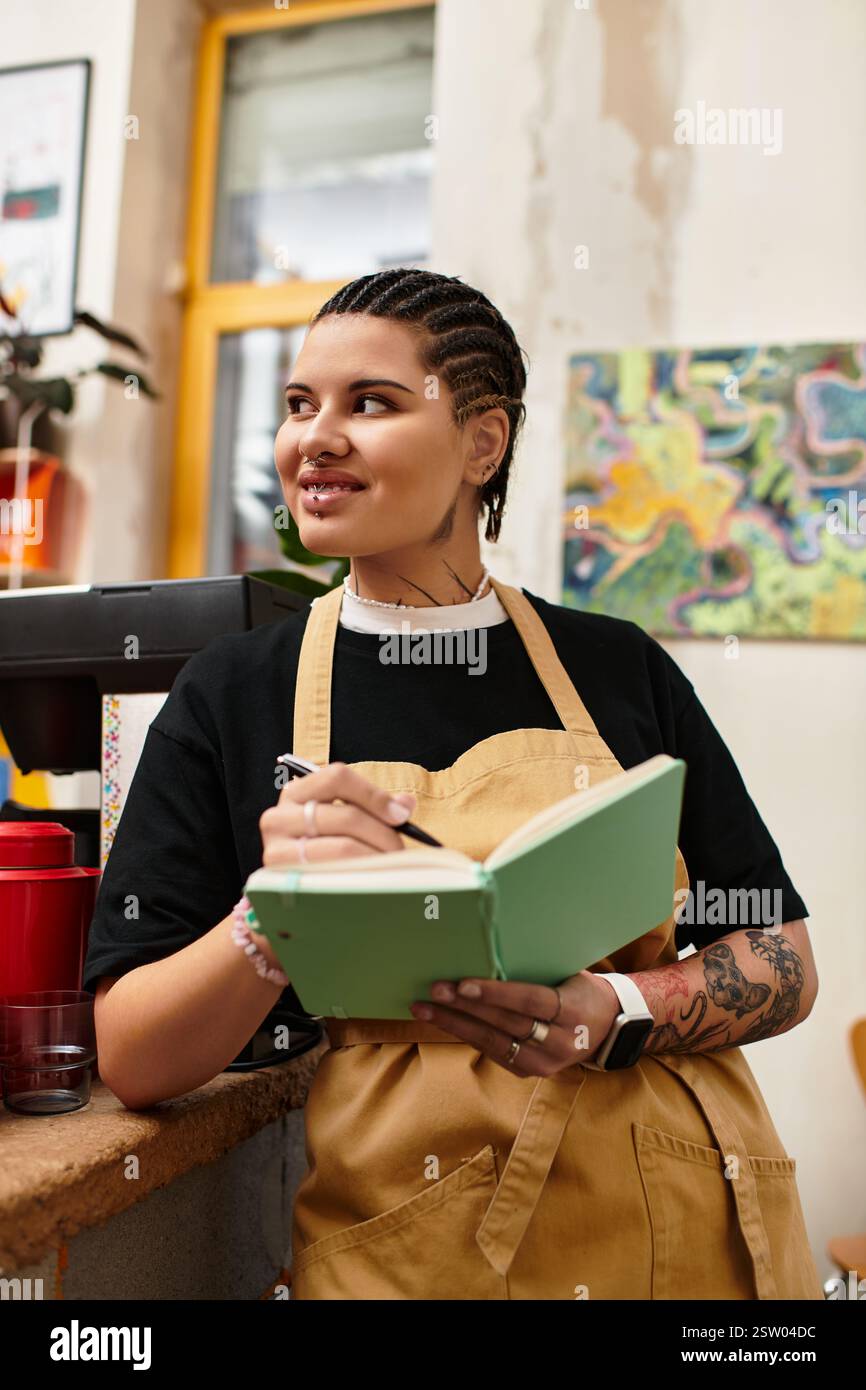 A young woman stands in a lively cafe, smiling as she writes in her ...