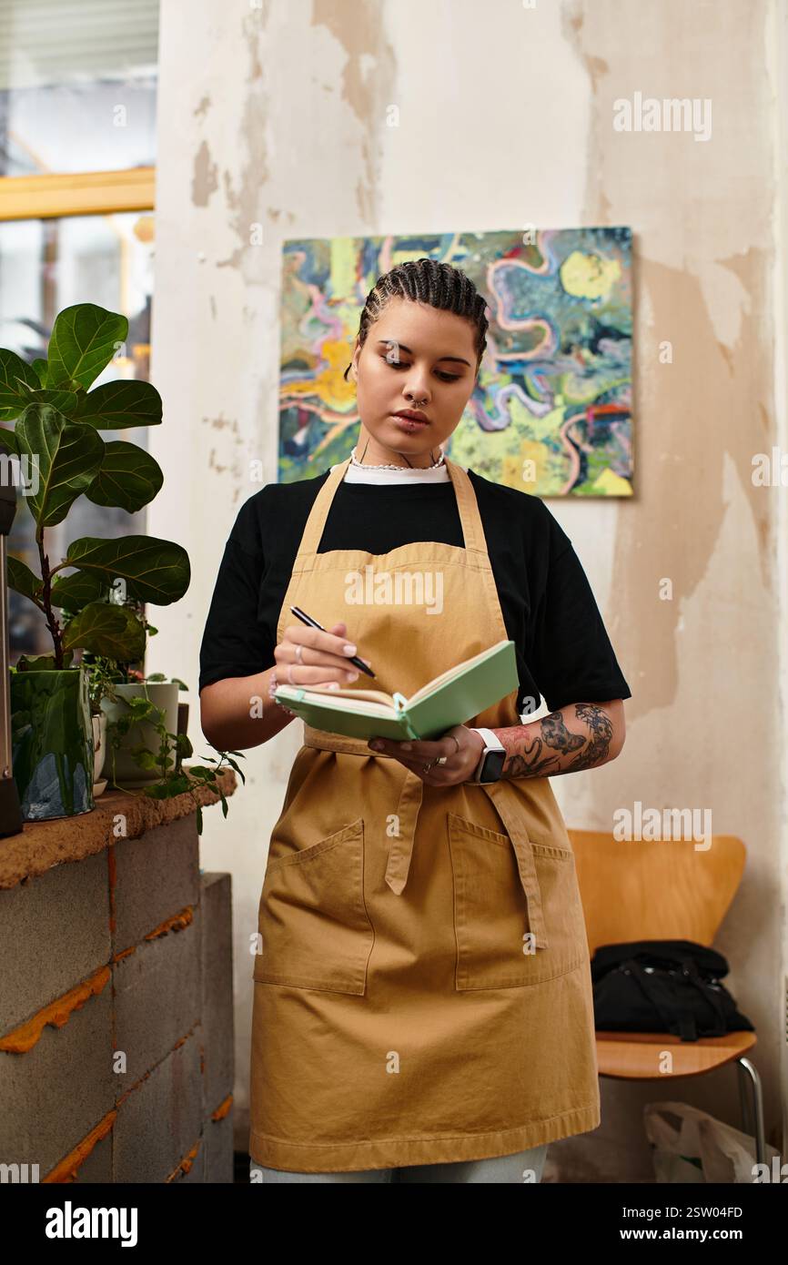 A young woman stands in a cafe, jotting down notes with a focused look ...