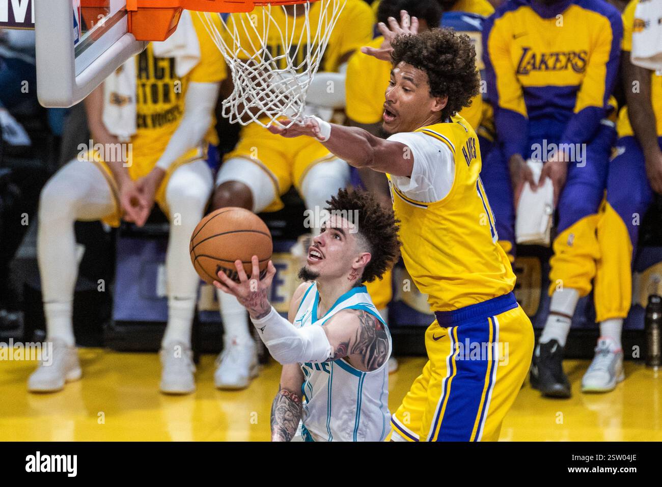 Charlotte Hornets' LaMelo Ball #1 goes to the basket under pressure ...