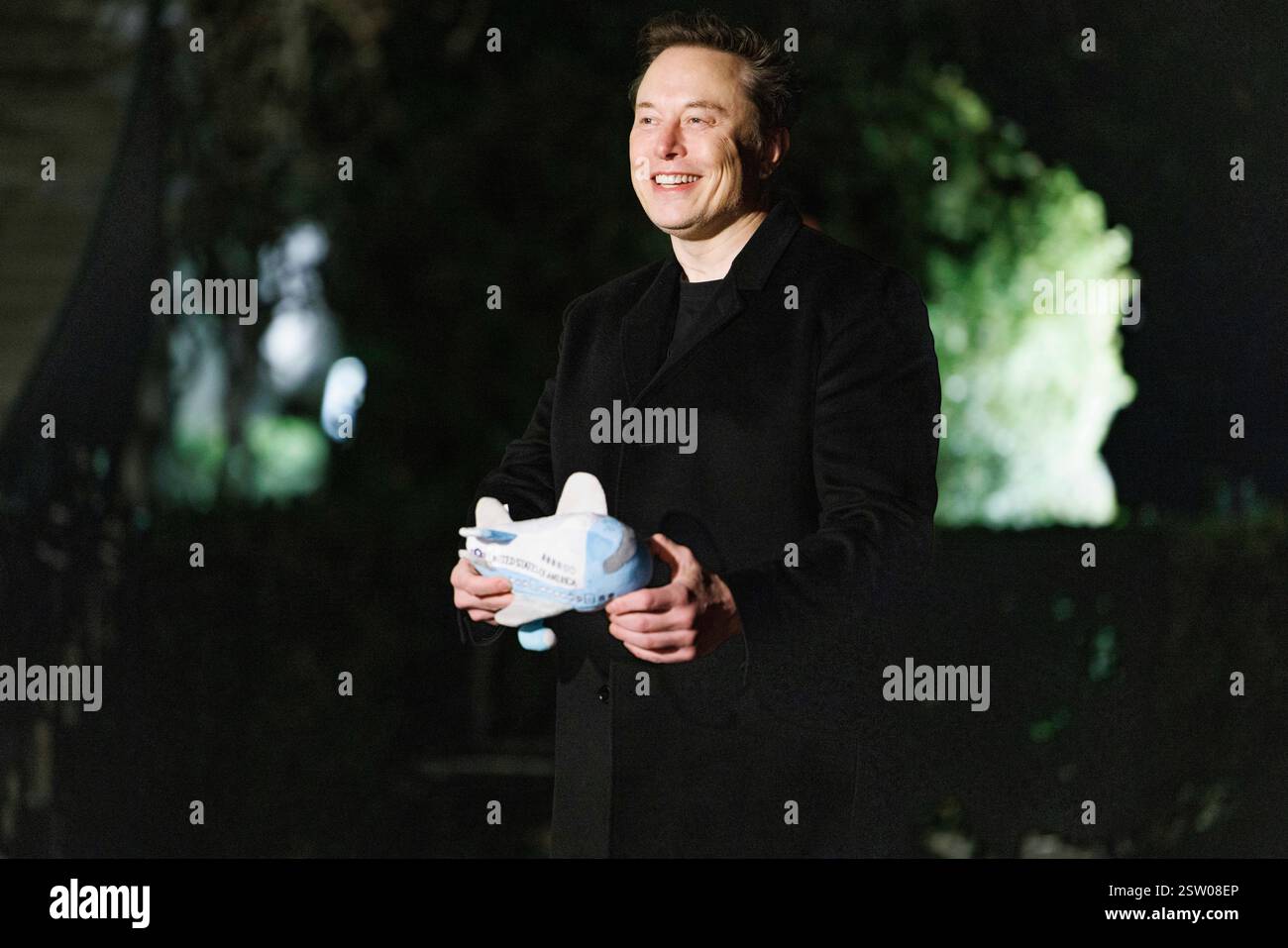 Elon Musk is seen with an Air Force One plush toy as he arrives at the ...