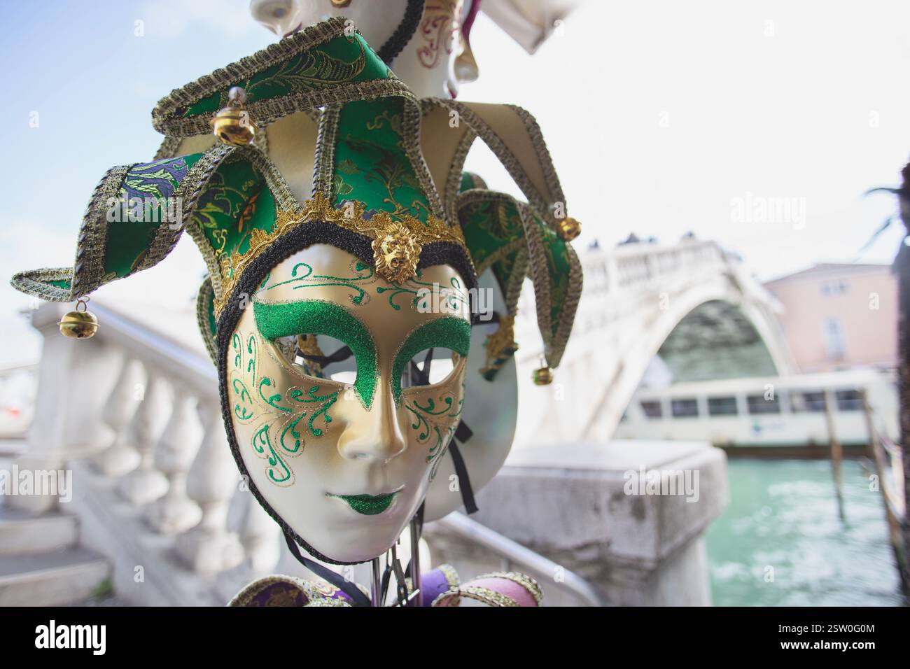 Carnival mask hanging in a stall with the Venice bridge in the ...