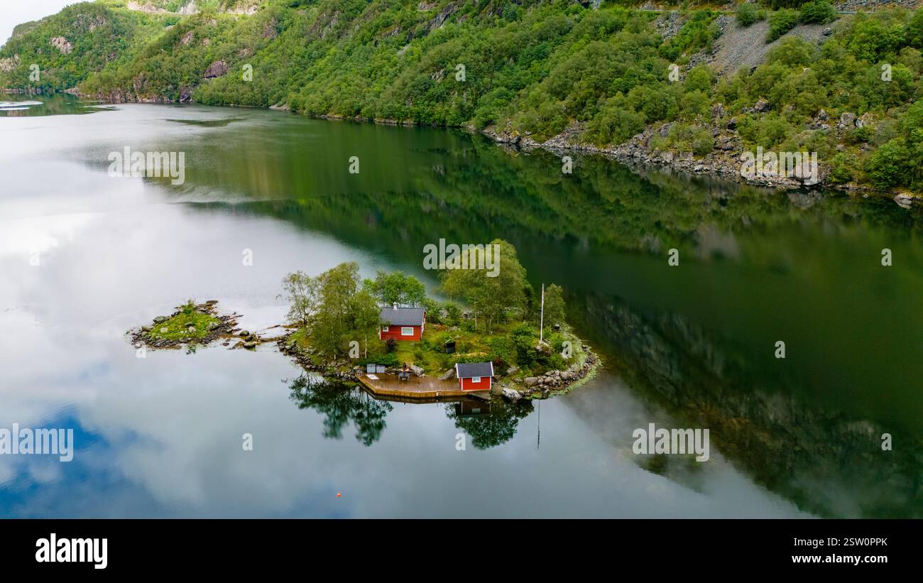 An aerial view of a small, verdant island nestled in a serene Norwegian ...