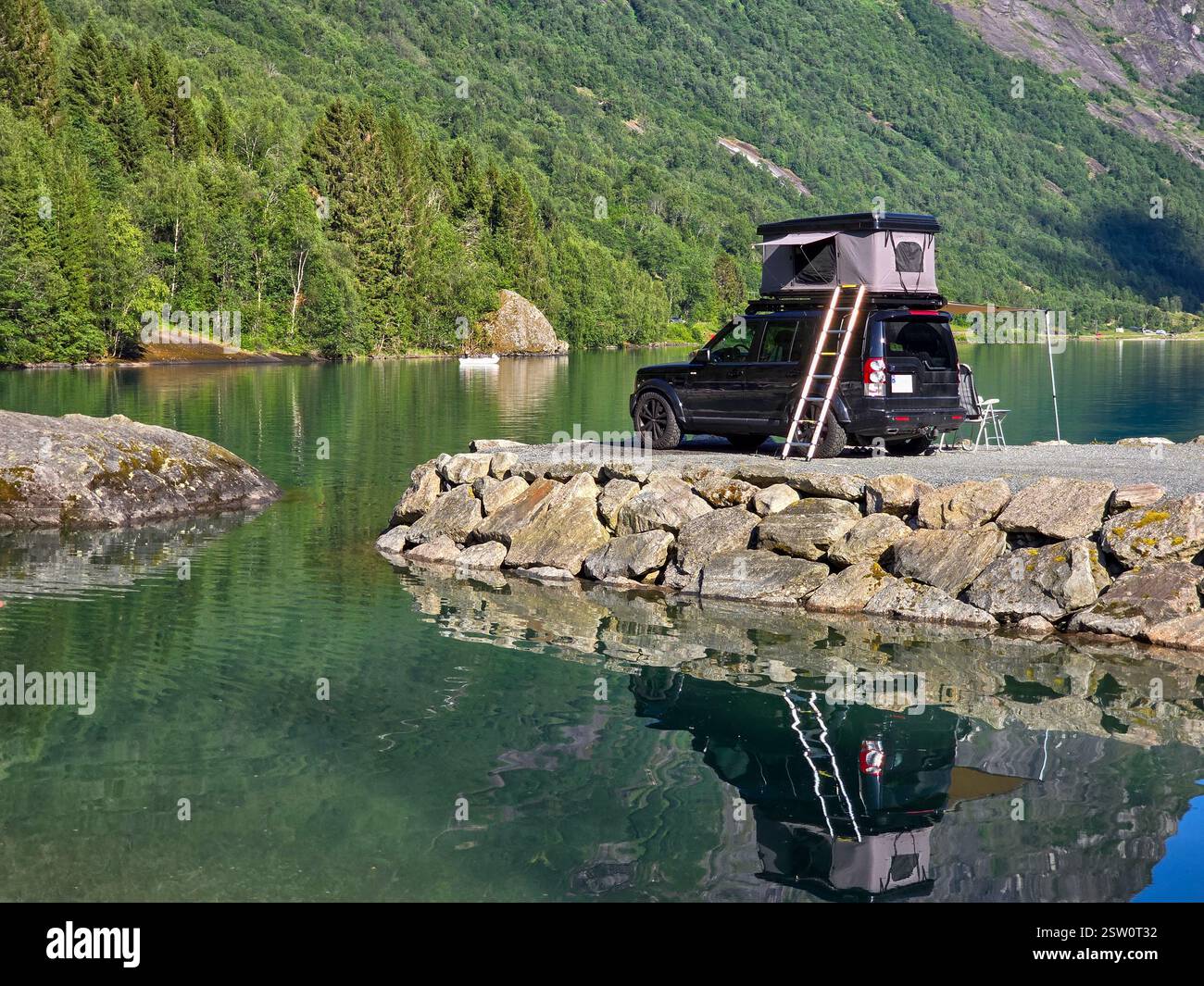Camping by the Tranquil Waters of Norway With a Rooftop Tent at Sunset ...