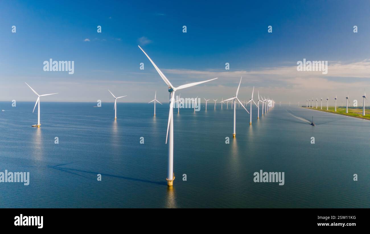 Wind Turbines Harnessing Renewable Energy in the Dutch Sea at Sunset Stock Photo - Alamy