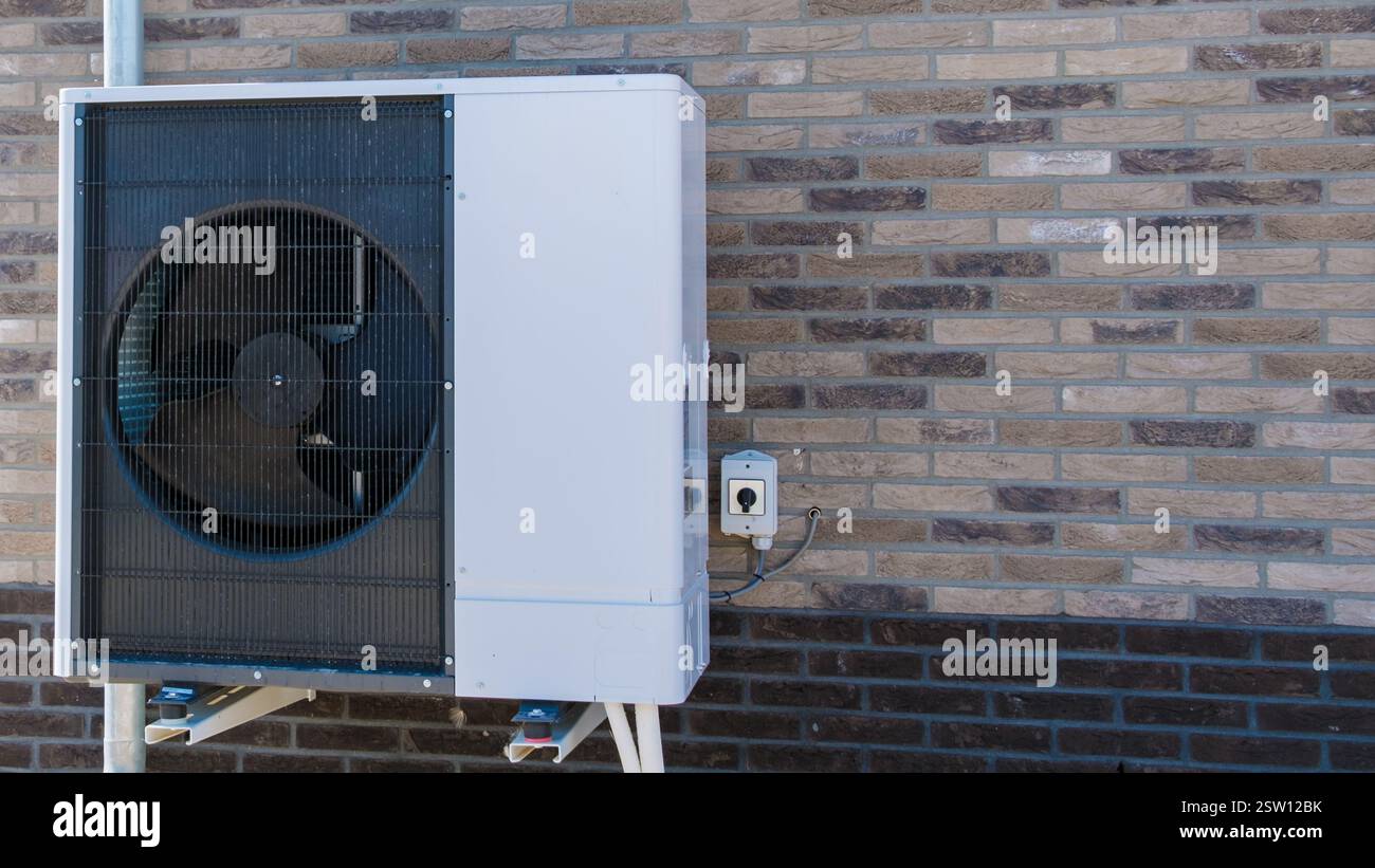 Air Source Heat Pump Installed on Modern Home Exterior Wall Stock Photo - Alamy