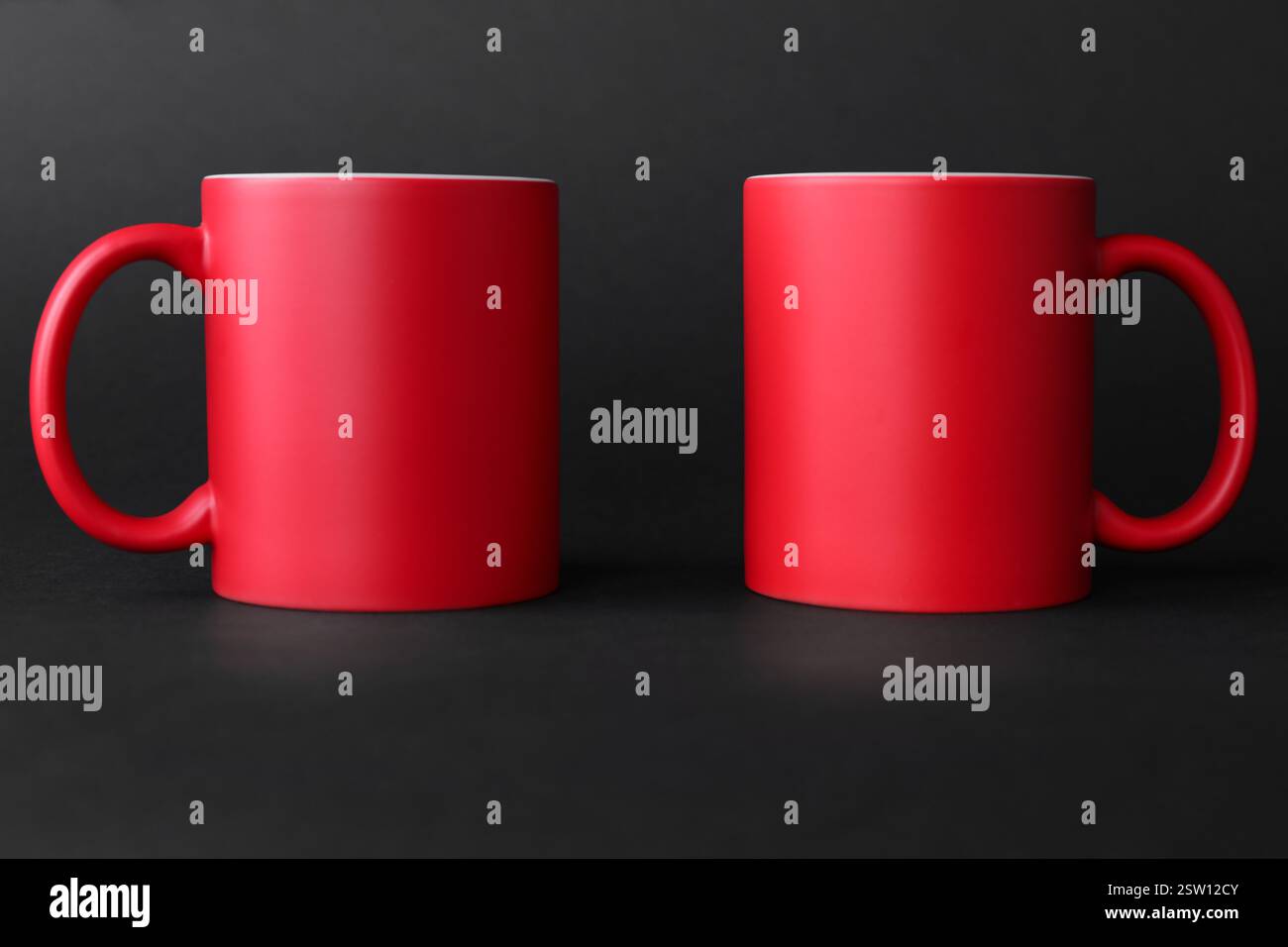 Two blank red mugs on black background. Mockup for design Stock Photo ...
