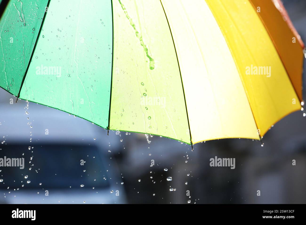 Open bright umbrella under pouring rain outdoors, closeup Stock Photo ...