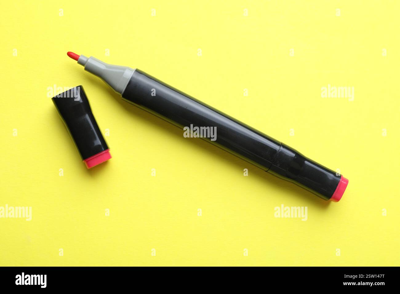 One double sided marker on yellow background, top view Stock Photo - Alamy