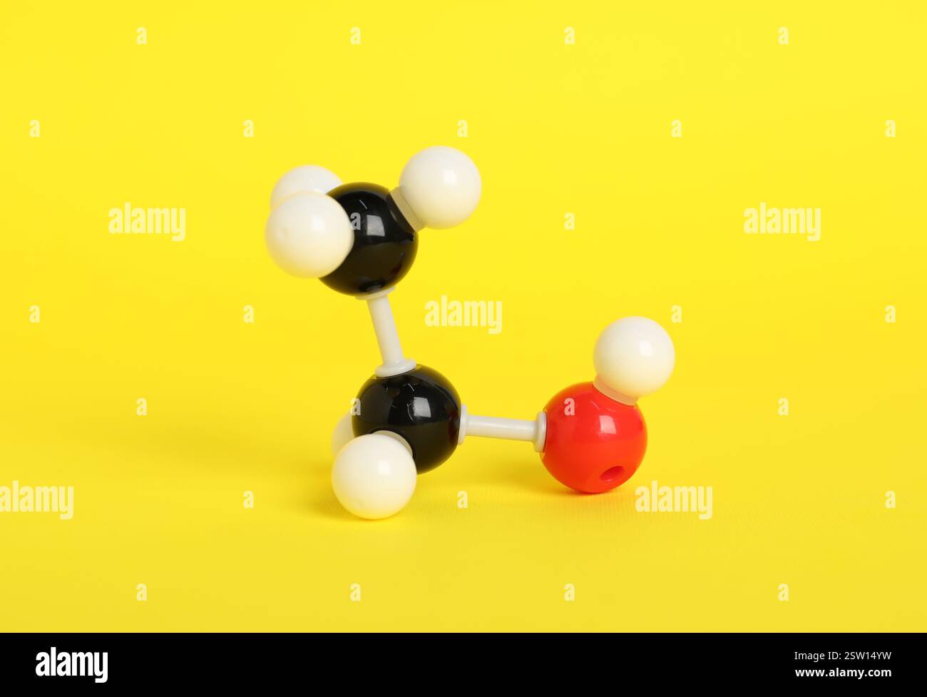 Molecule of ethanol on yellow background. Chemical model Stock Photo ...
