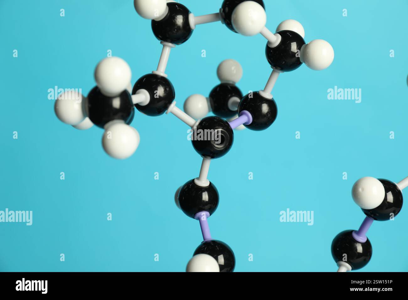 Molecule of retinol (vitamin A) on light blue background, closeup ...