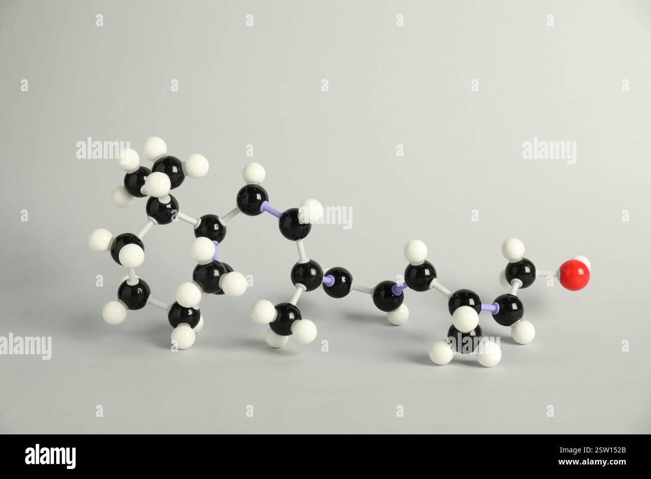 Molecule of retinol (vitamin A) on light grey background. Chemical ...