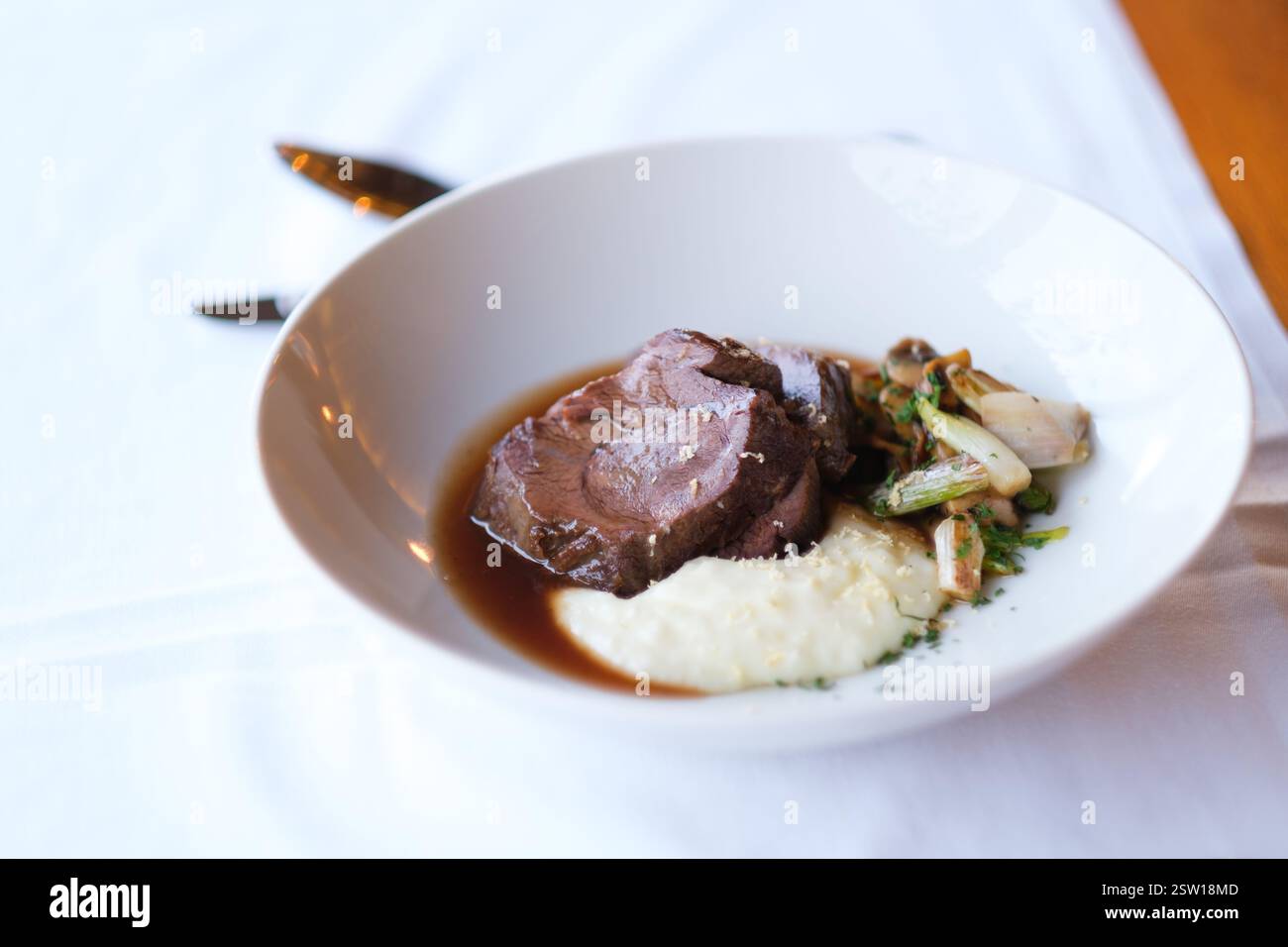 A gourmet meal featuring a rich meat entree served with creamy mashed ...