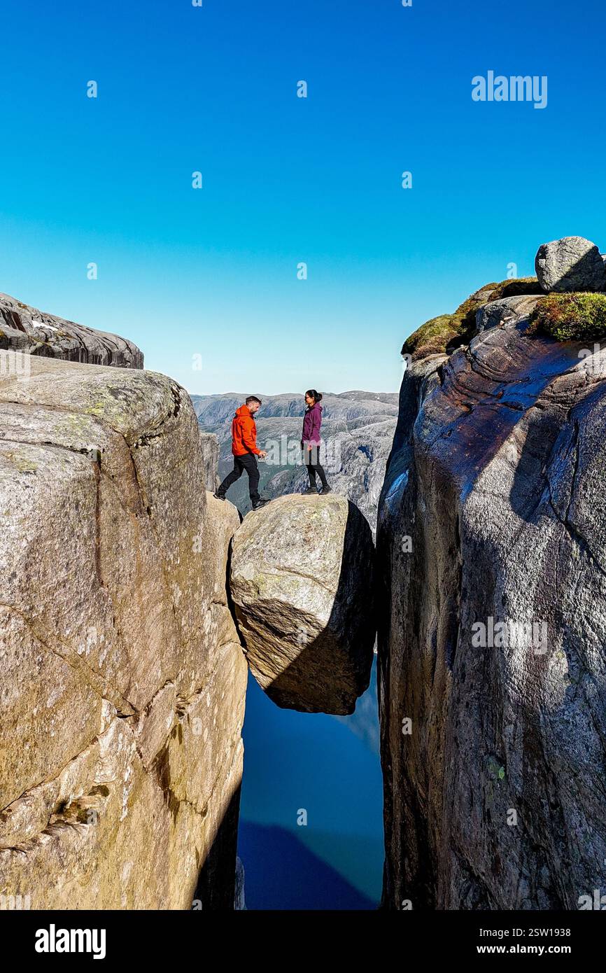 Two explorers traverse a natural stone bridge amidst breathtaking ...