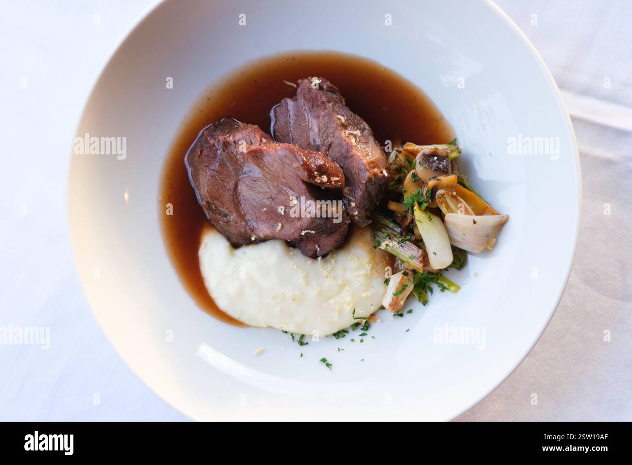 Braised meat with creamy mashed potatoes and sautéed vegetables Stock ...